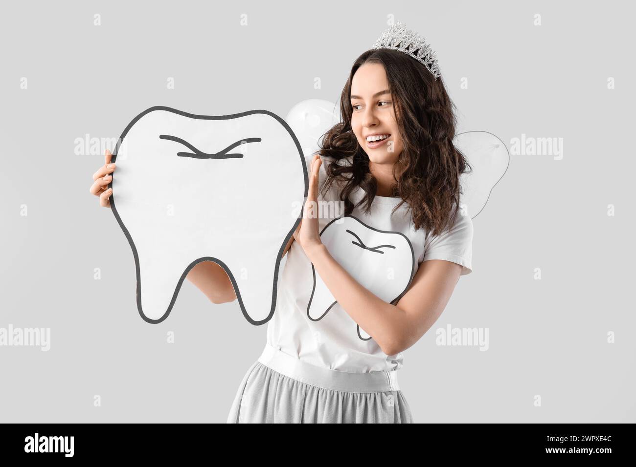 Tooth Fairy with paper figure on light background Stock Photo - Alamy