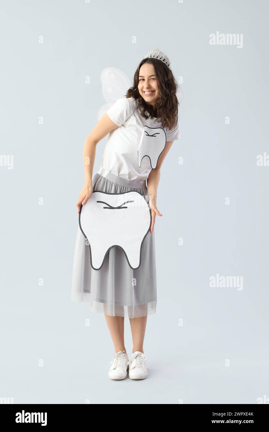 Tooth Fairy with paper figure on light background Stock Photo - Alamy