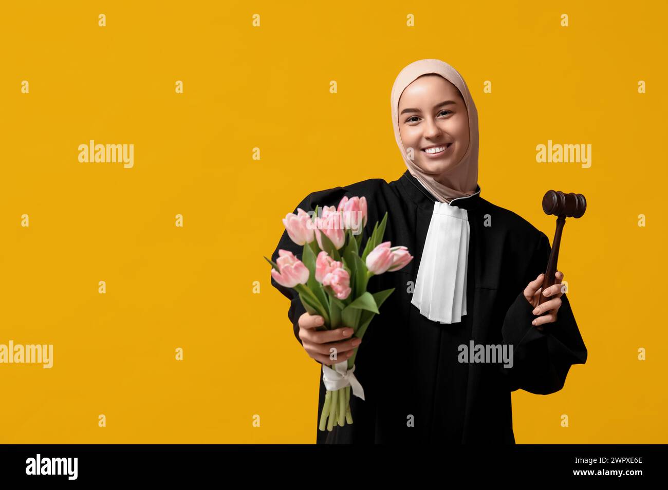 Muslim female judge with pink tulips on yellow background. Women's Day ...