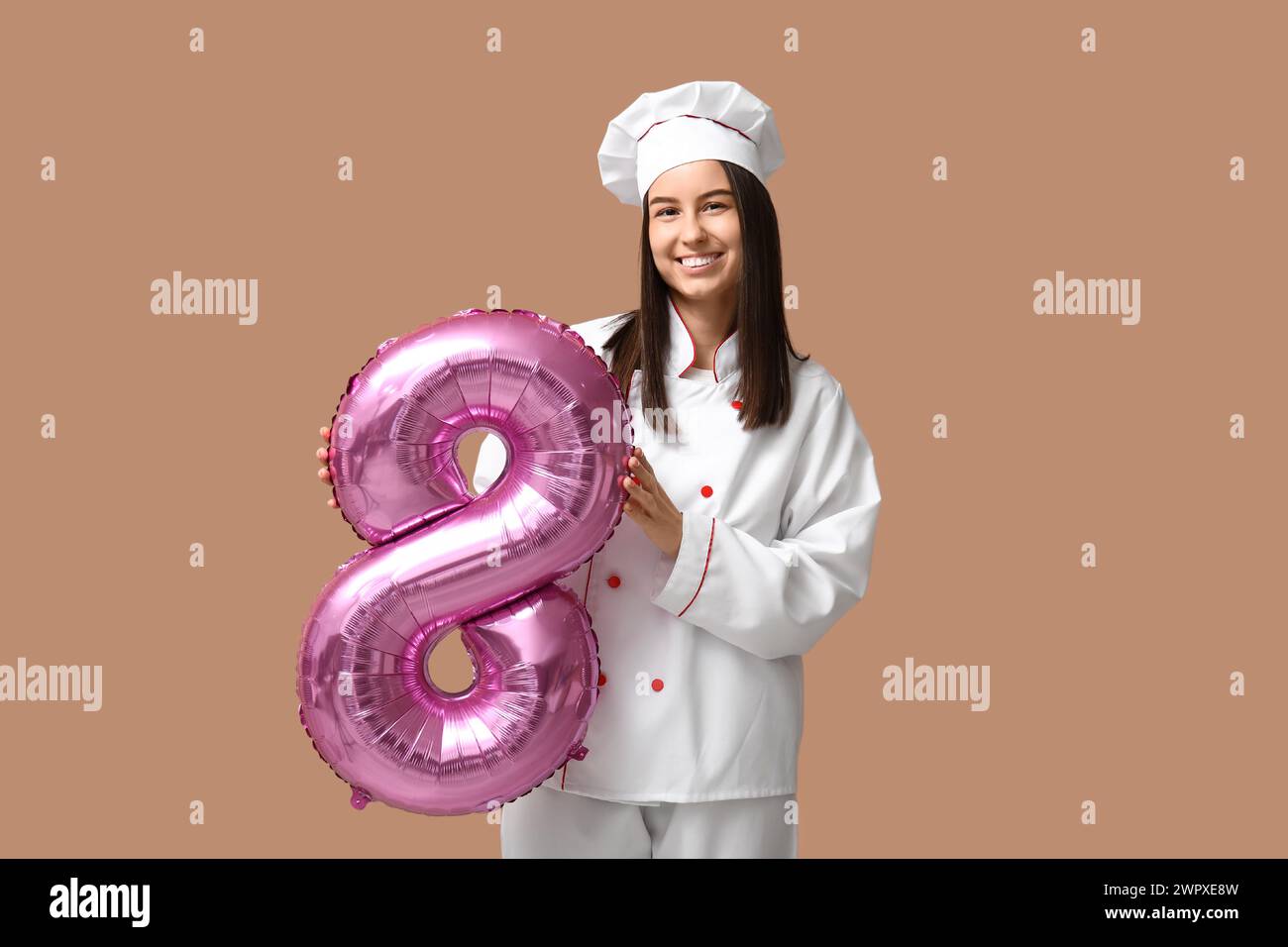 Female chef with balloon in shape of figure 8 on beige background ...