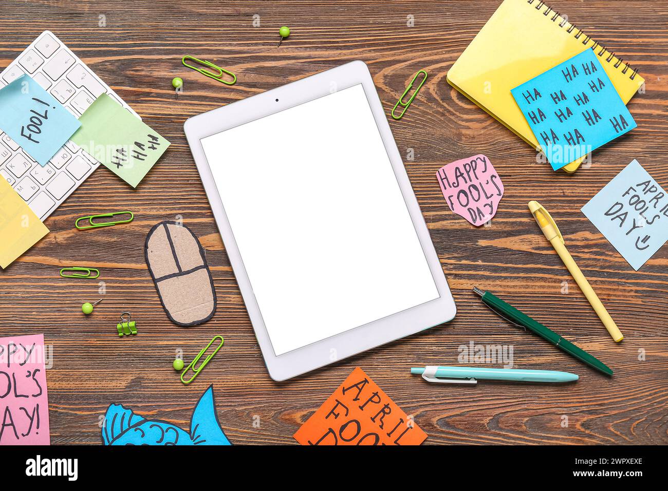 Tablet, computer keyboard, carton mouse and sticky notes. April Fools ...