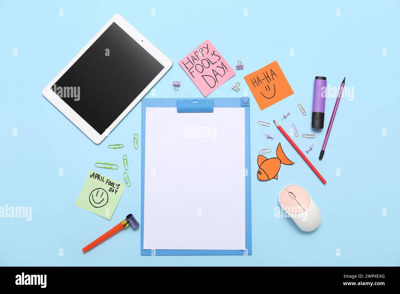 Modern tablet, clipboard and sticky notes on blue background. April ...