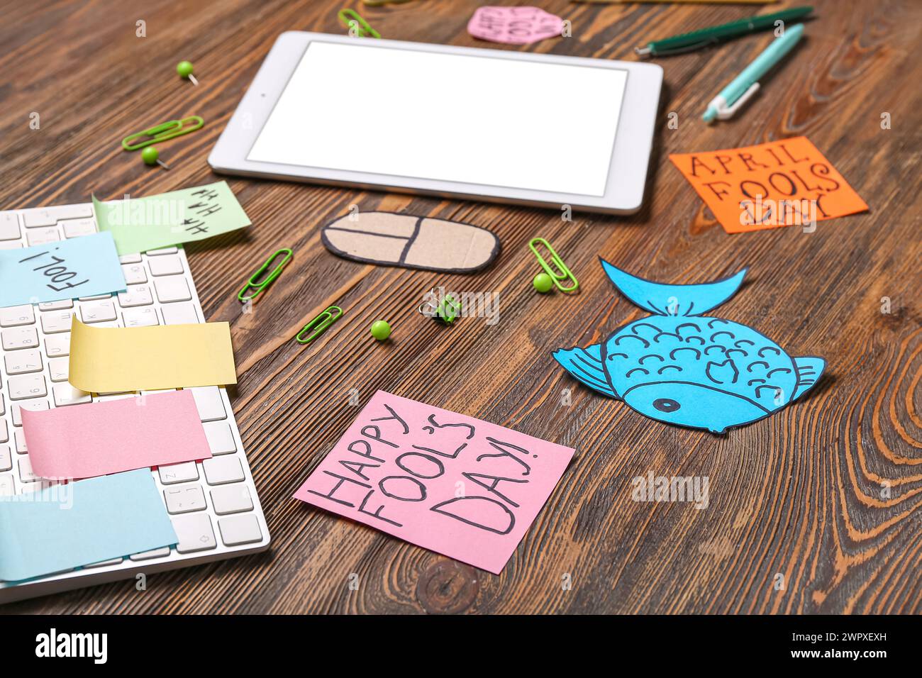 Tablet, computer keyboard, carton mouse and sticky notes. April Fools ...