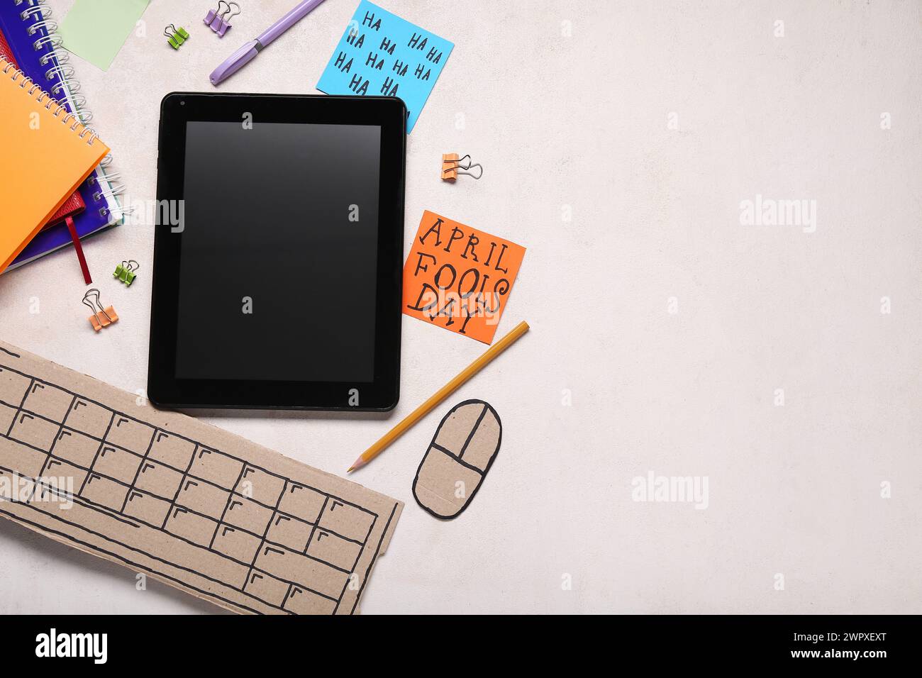 Modern tablet, carton computer keyboard and sticky notes. April Fools ...