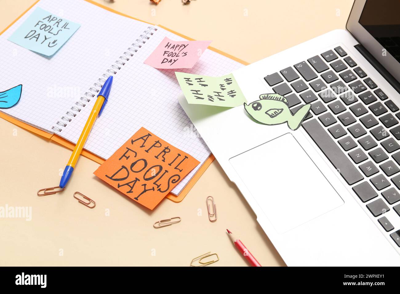 Laptop, notebook, stationery and sticky notes on beige background ...
