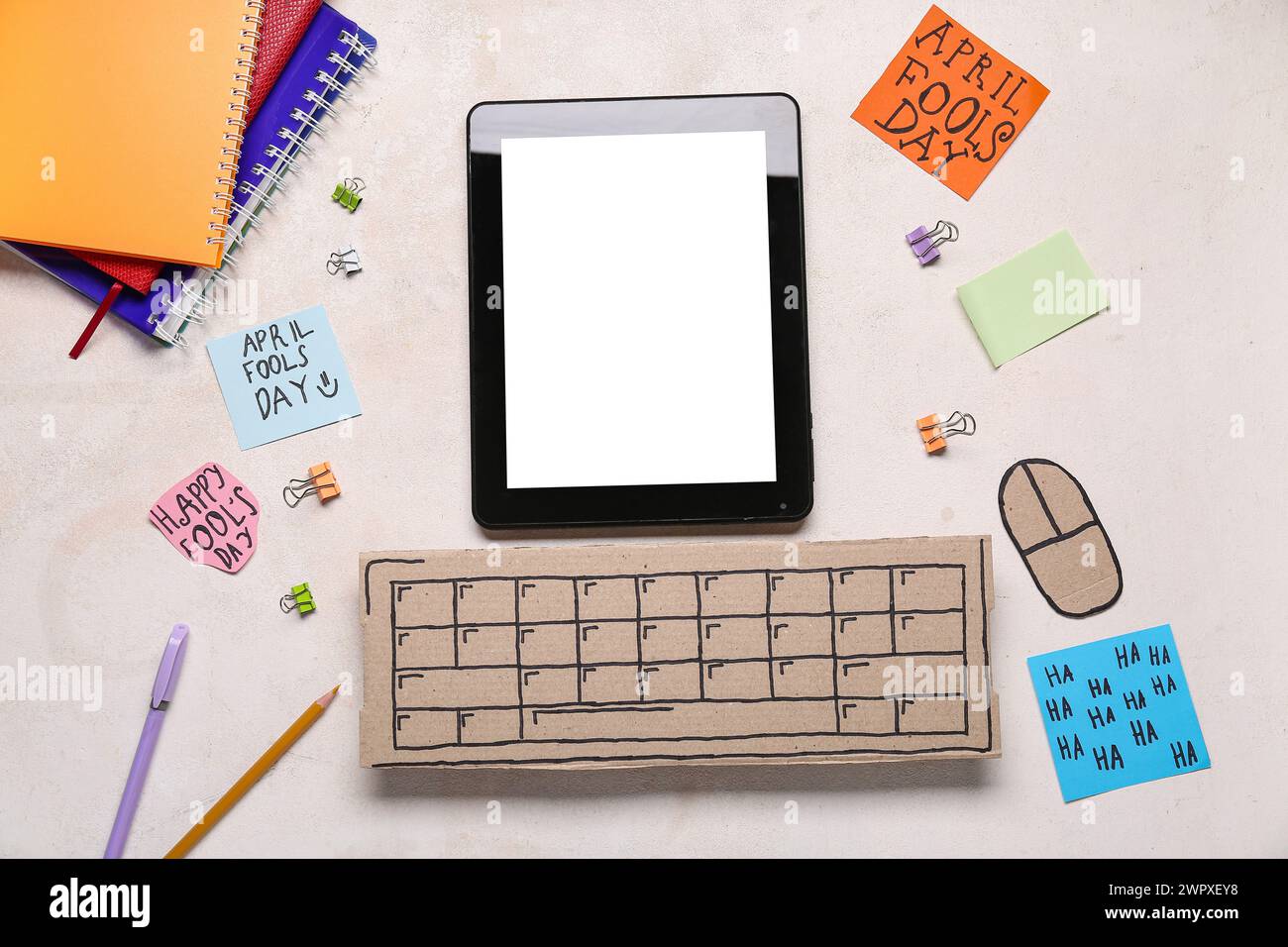 Modern tablet, carton computer keyboard and sticky notes. April Fools ...