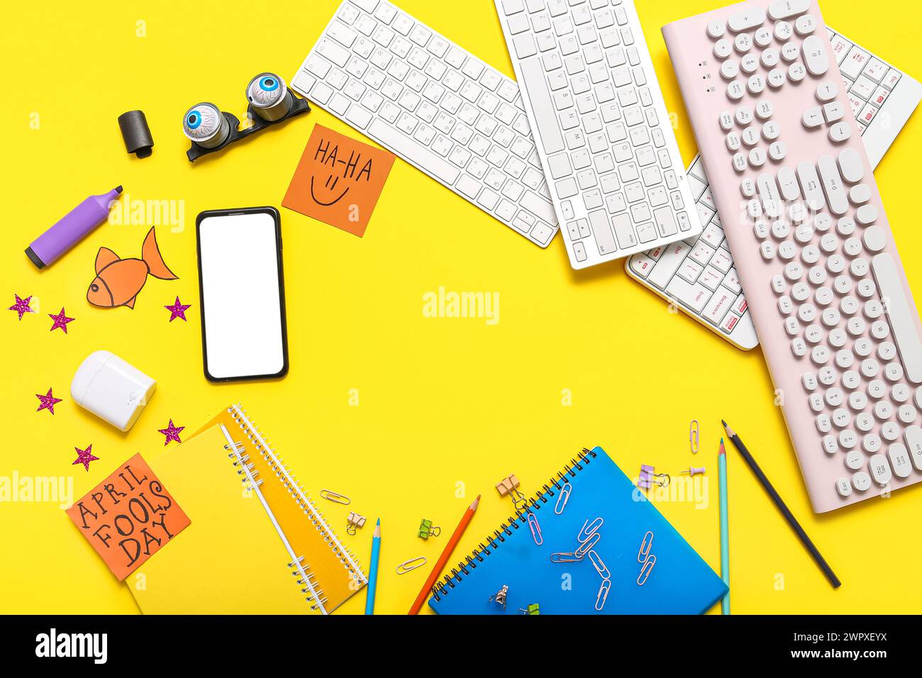 Frame made of phone, computer keyboards, notebooks and sticky notes on ...