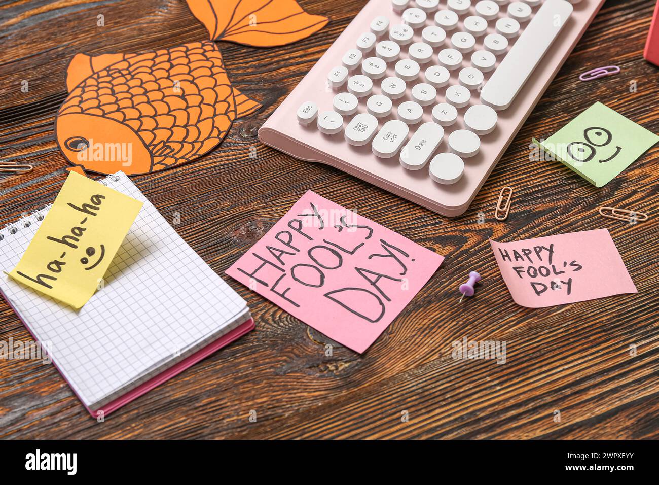 Computer keyboard, notebook and sticky notes on wooden background ...