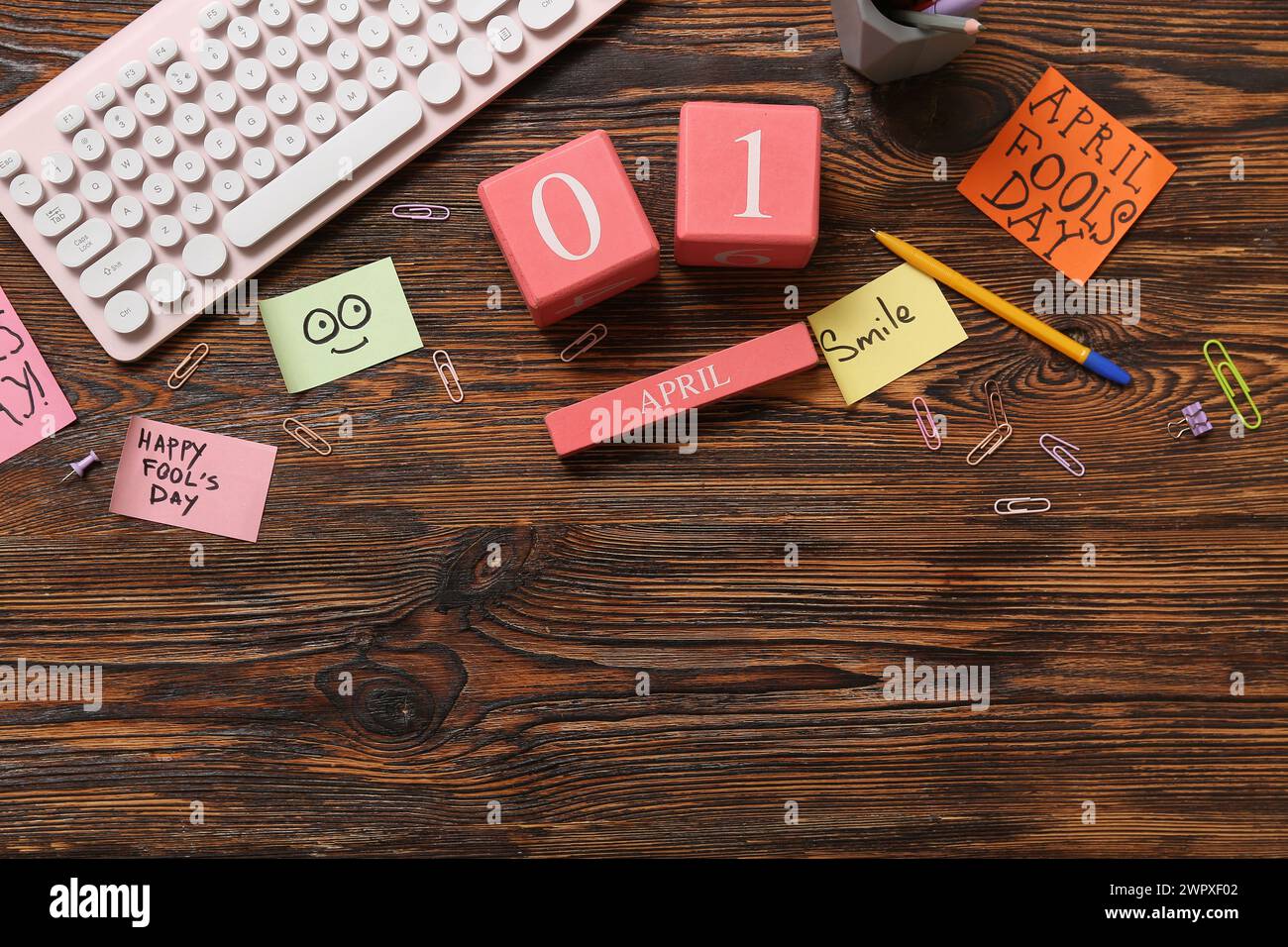 Computer keyboard, calendar and sticky notes on wooden background ...