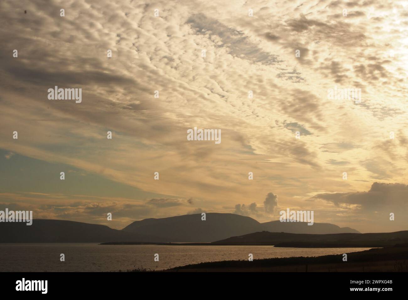 Dramatic, summer evening sky at Orphir, Mainland Orkney, looking across ...