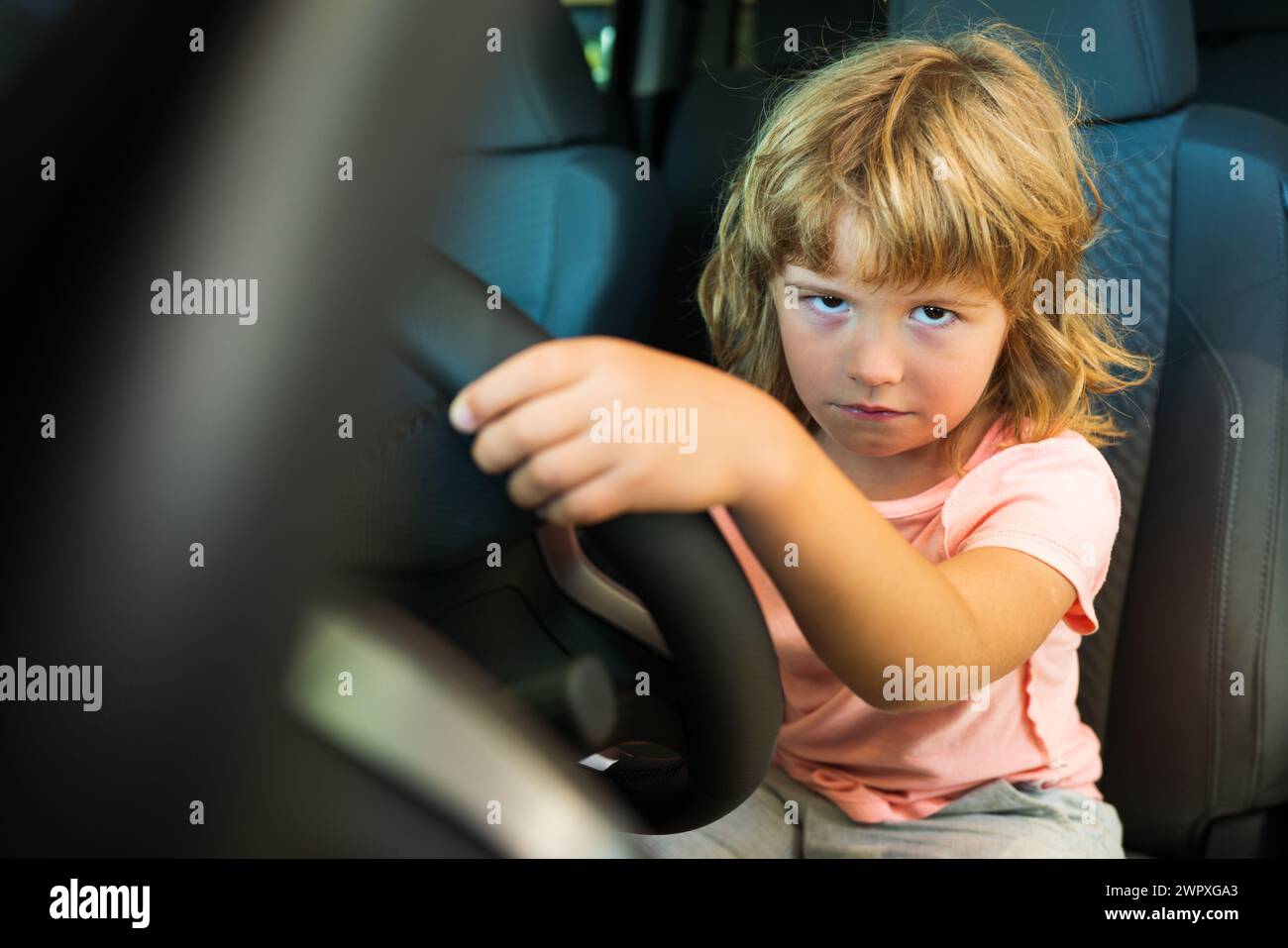 Little Driver. Cute little boy pretending to drive. Kid in car with his ...