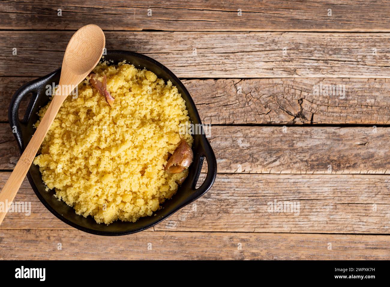 Rustic dish with wheat semolina crumbs and garlic, with a wooden spoon ...