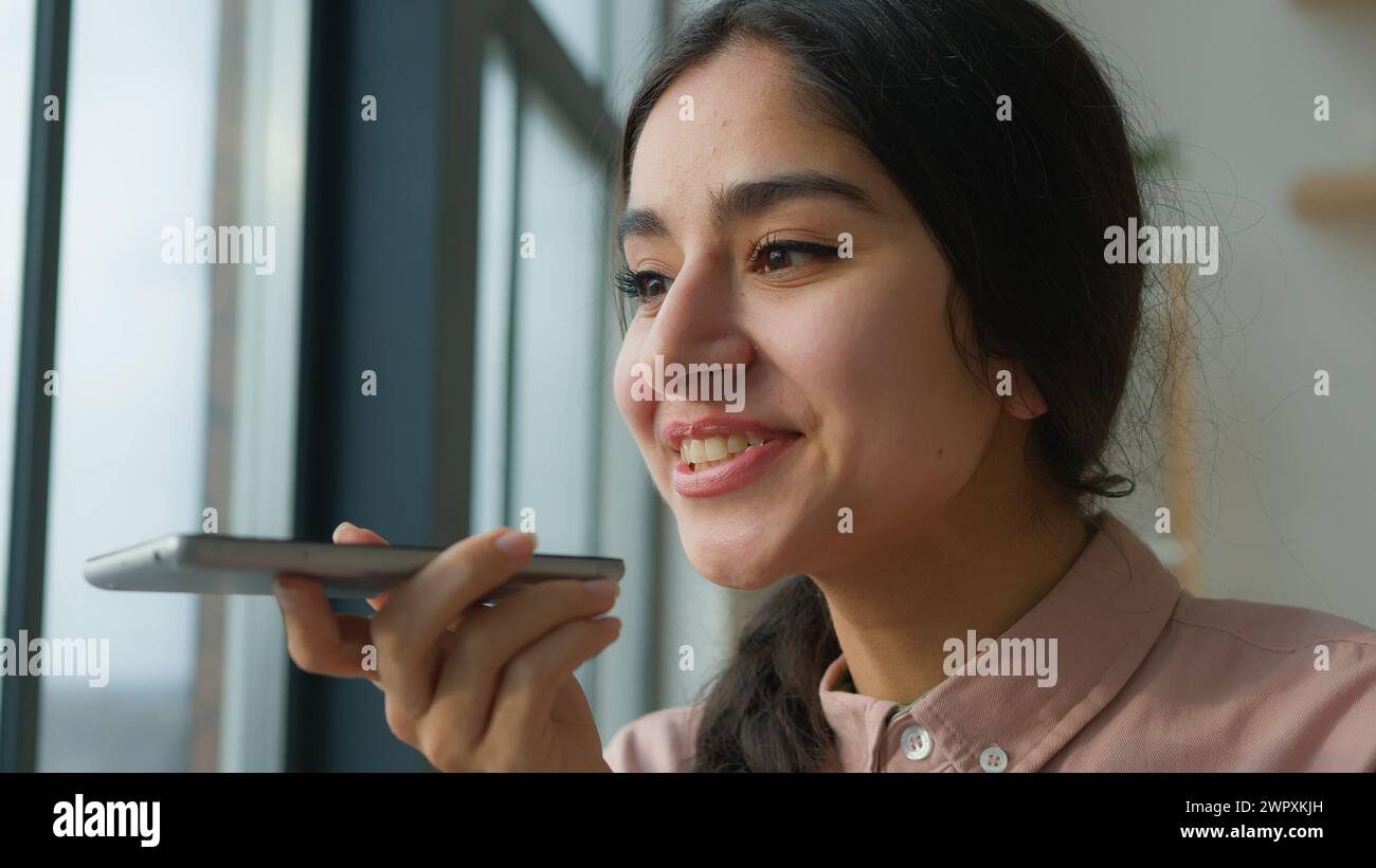 Happy cheerful Arabian Indian business girl talk mobile phone near ...