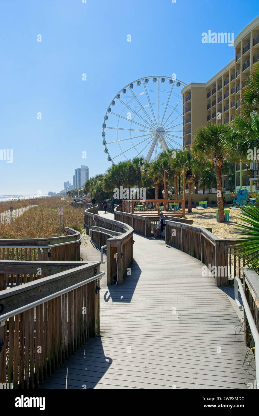 Boardwalk along hotel tower lined coast at Myrtle Beach, South Carolina ...