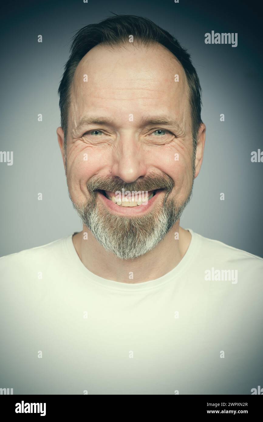 Portrait of aging man trying expressions in studio Stock Photo - Alamy