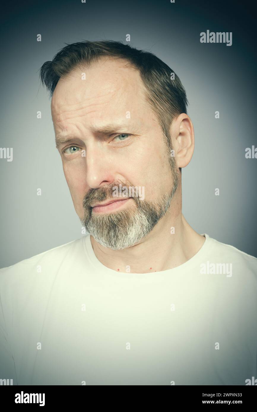 Portrait of aging man trying expressions in studio Stock Photo - Alamy