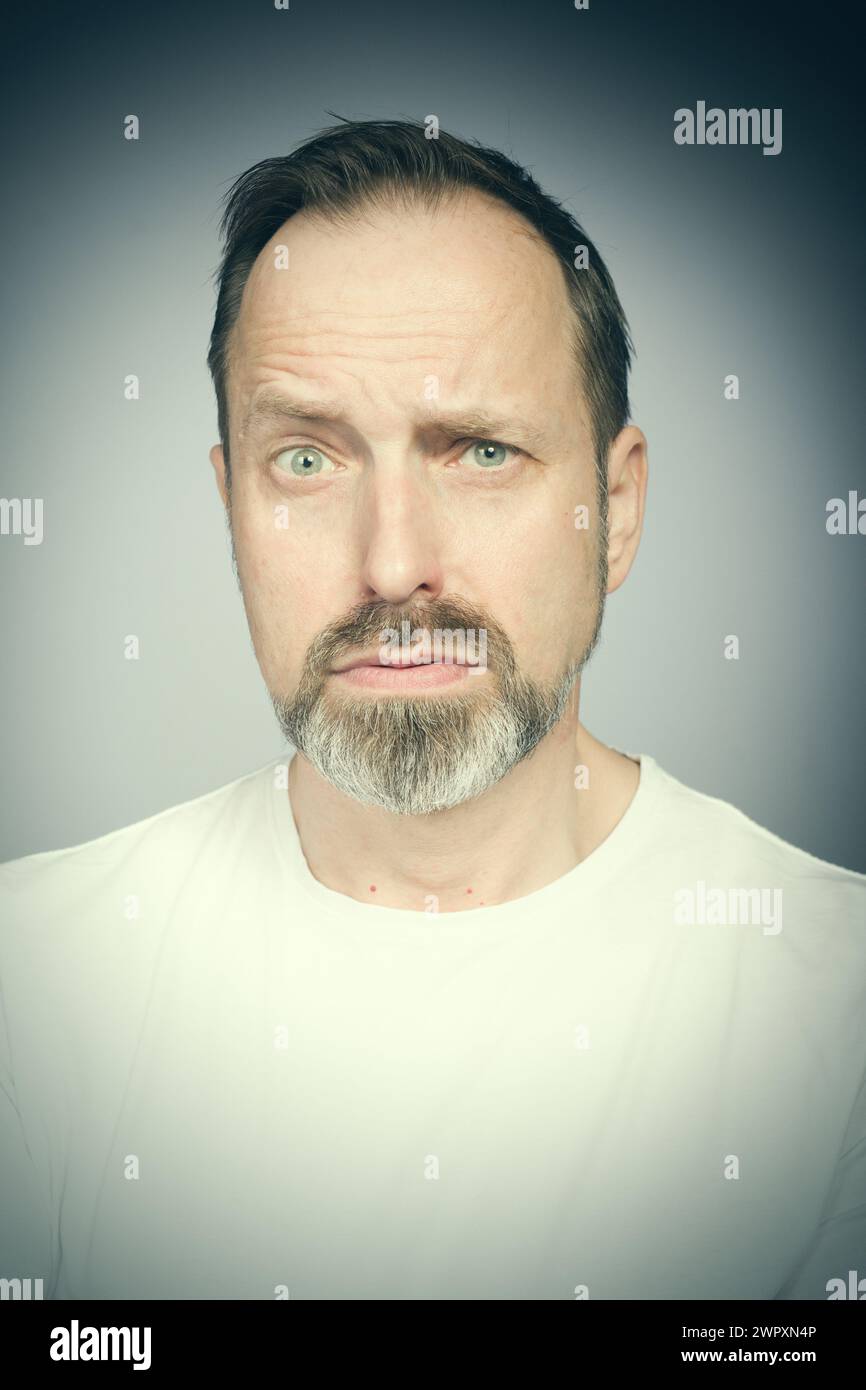 Portrait of aging man trying expressions in studio Stock Photo - Alamy