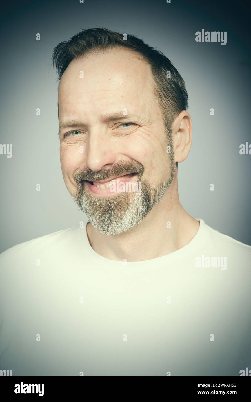 Portrait of aging man trying expressions in studio Stock Photo - Alamy