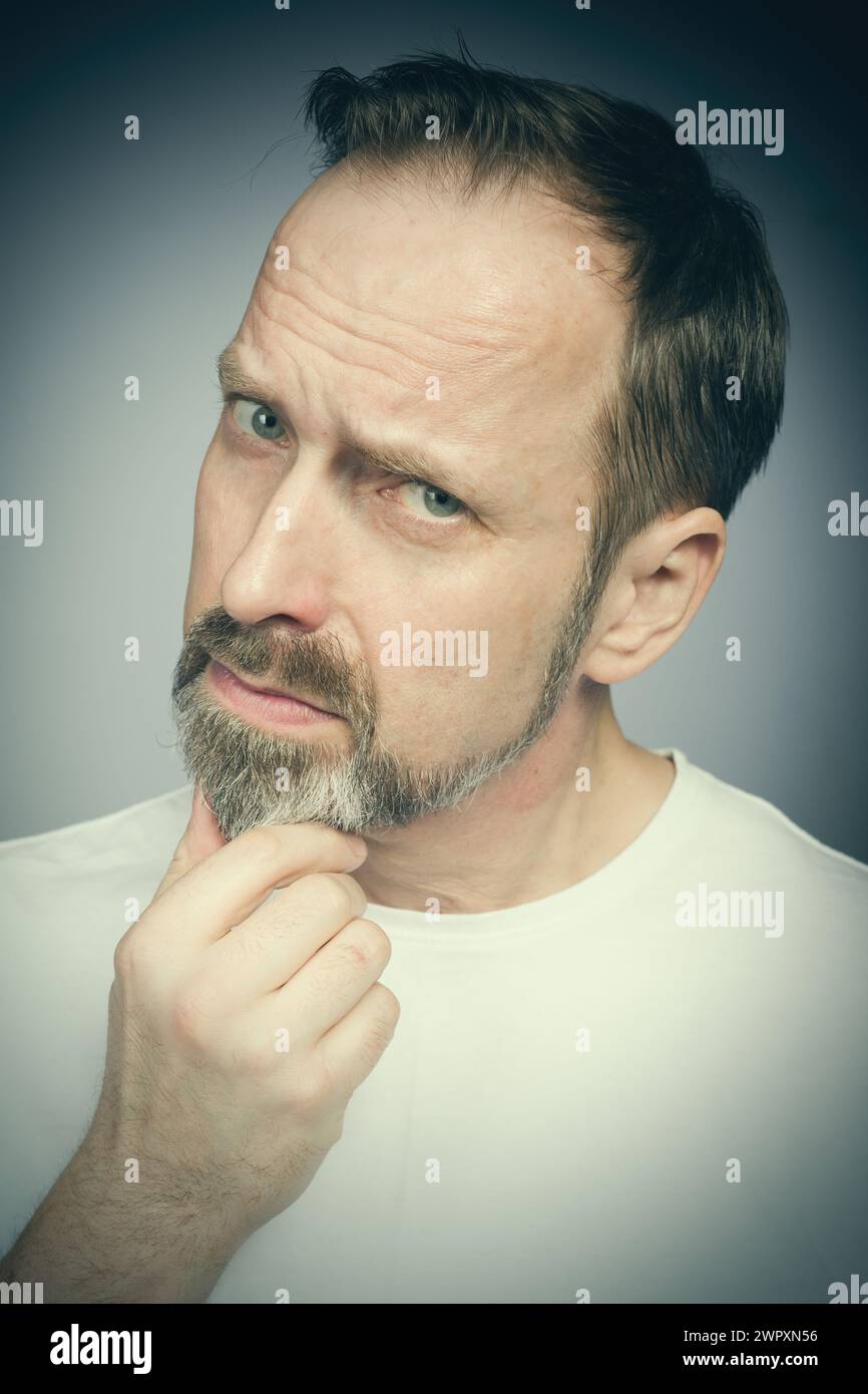 Portrait of aging man trying expressions in studio Stock Photo - Alamy