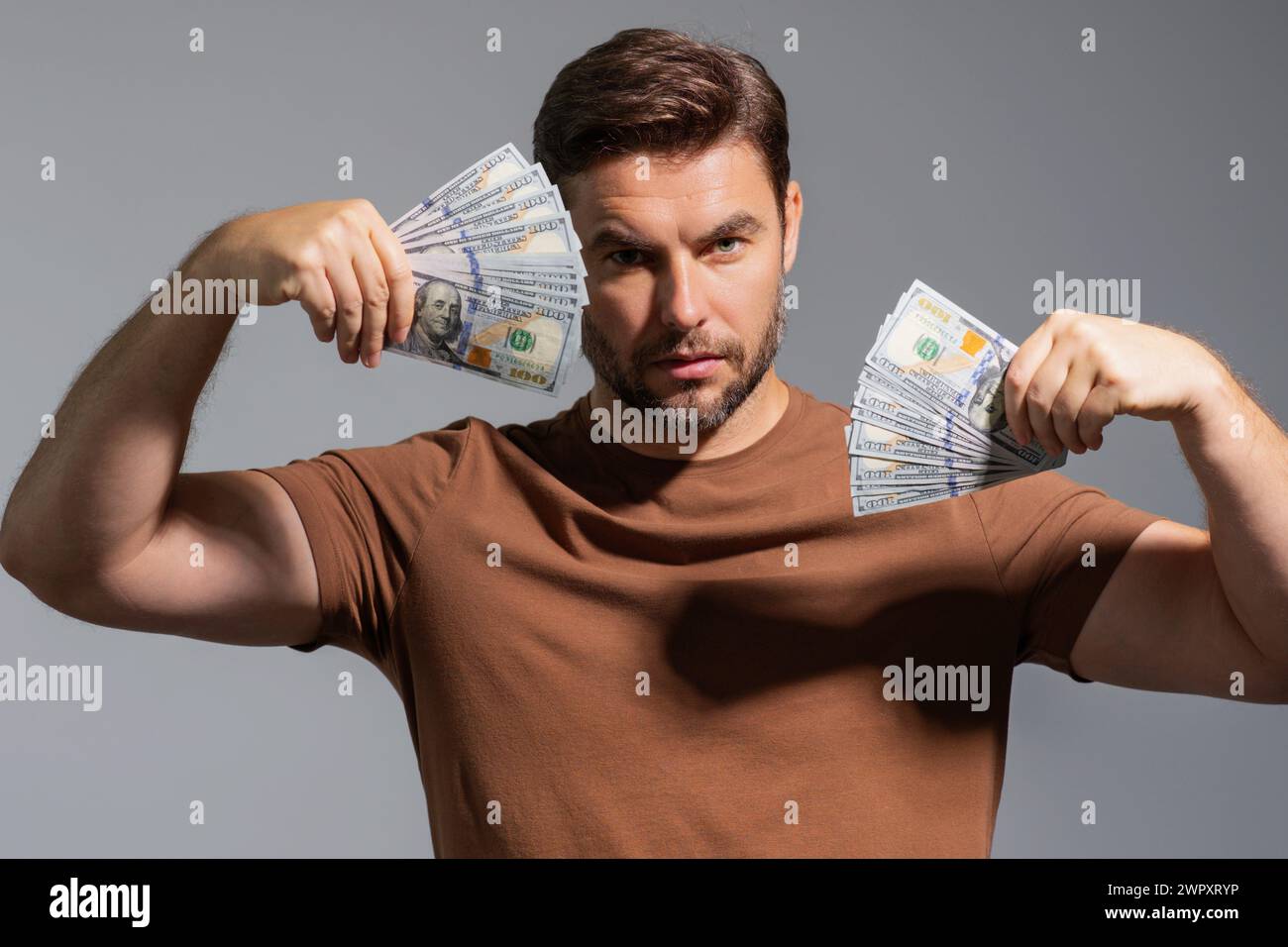 Business man hold money on gray studio isolated background. Rich man in ...