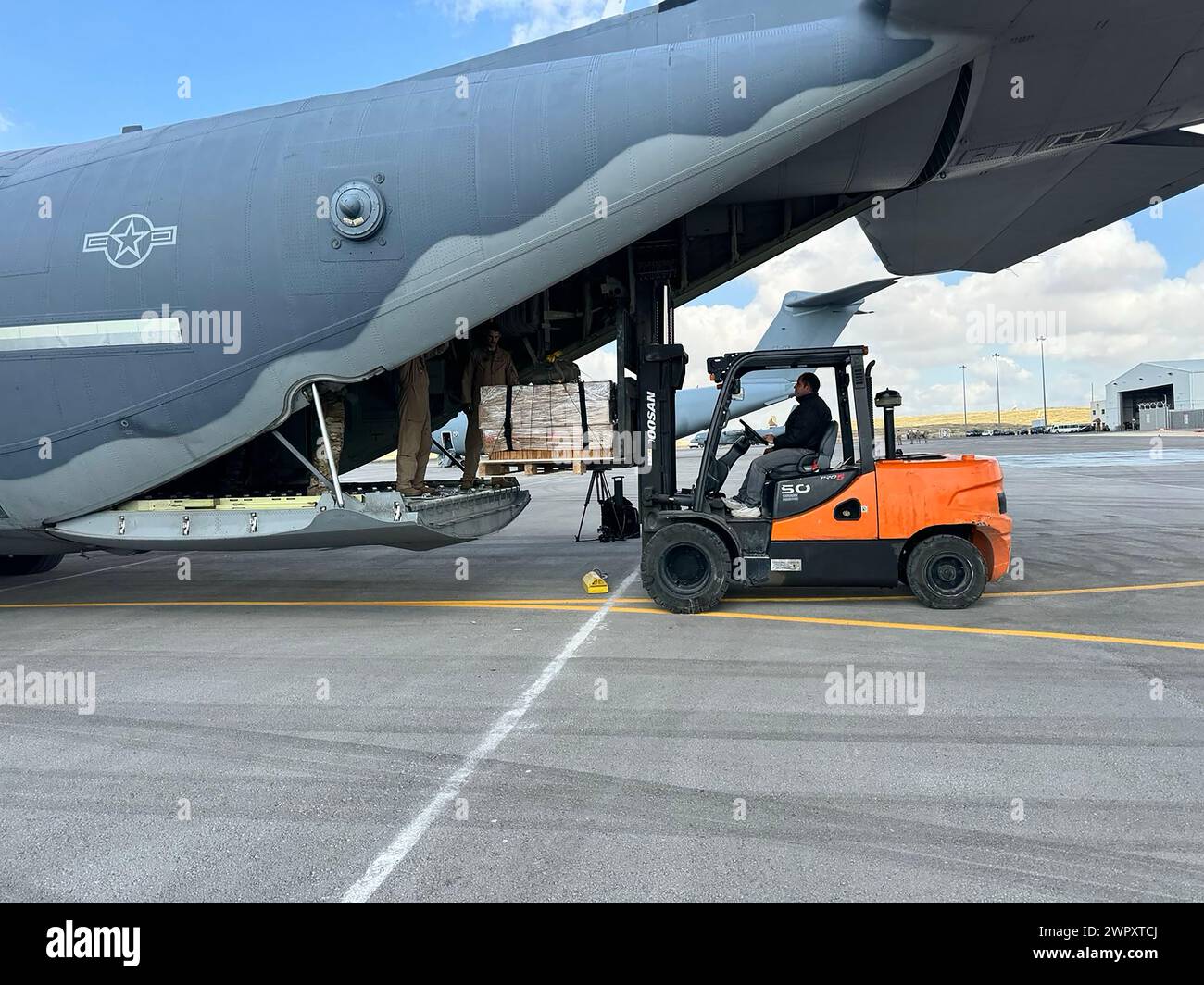 U.S. Air Force Airmen load bundles of humanitarian assistance for ...