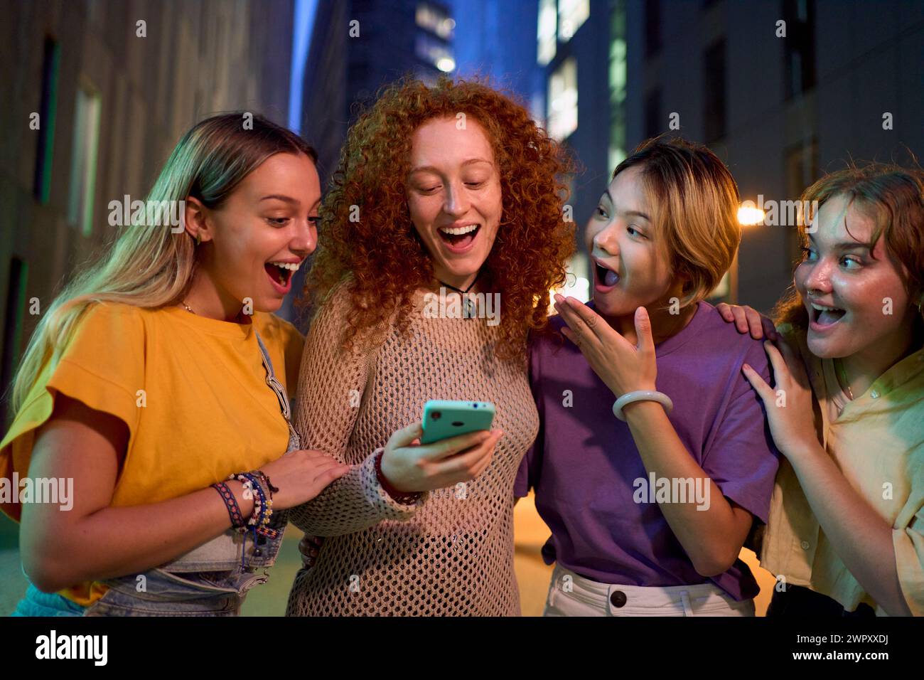 Young group of gen z people having fun using cell phone together ...