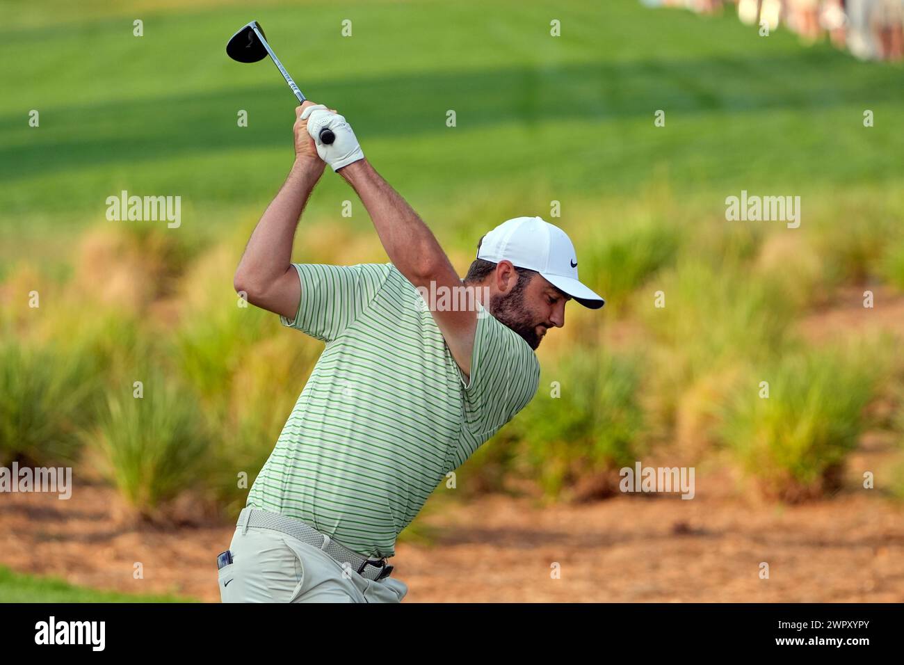 Scottie Scheffler tees off on the 18th hole during the third round of ...