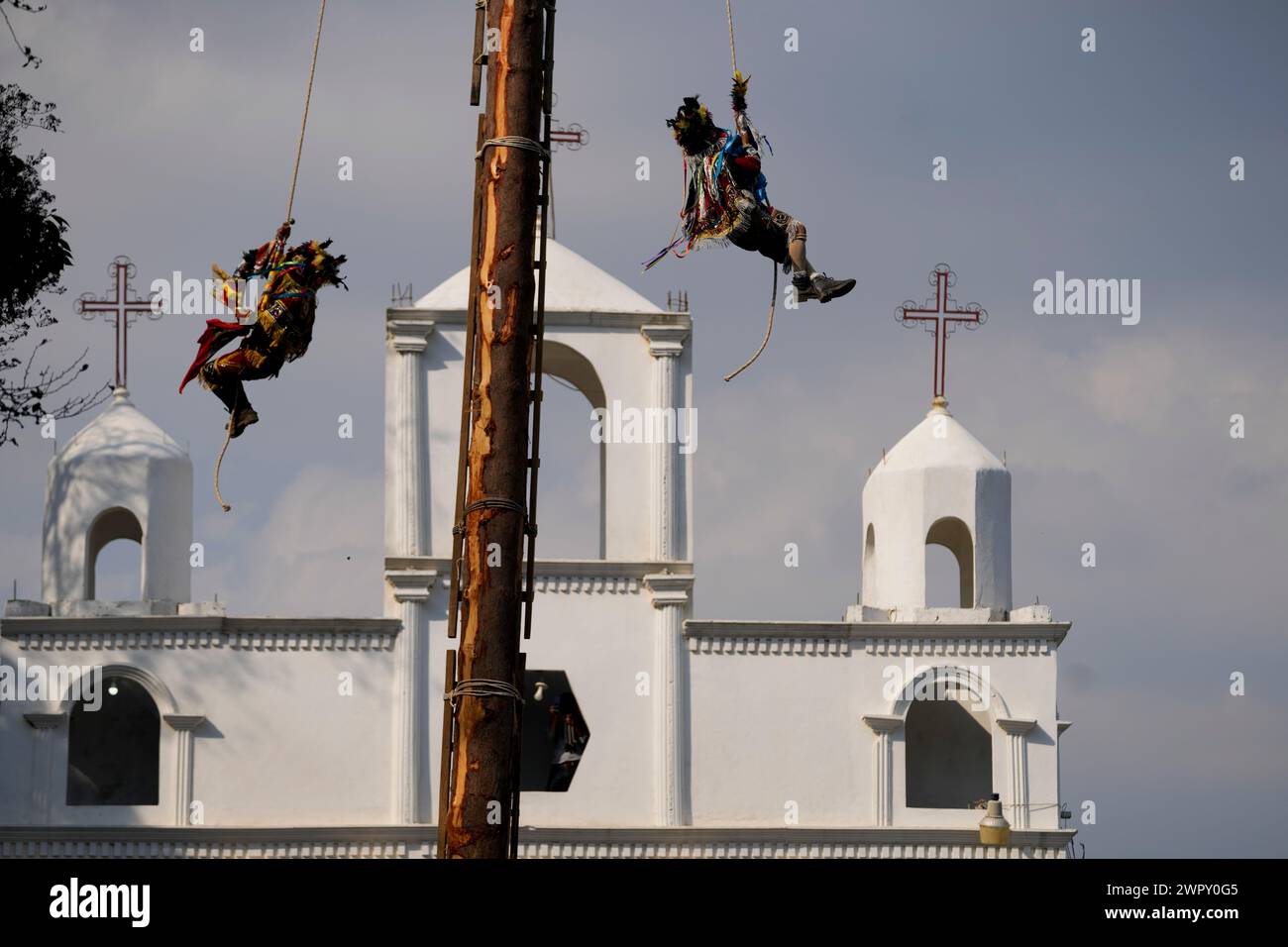 Dancers swing from a pole using ropes during the "Danza del Palo ...