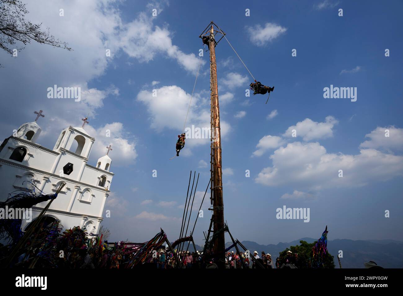 Dancers swing from a pole using ropes during the the "Danza del Palo ...