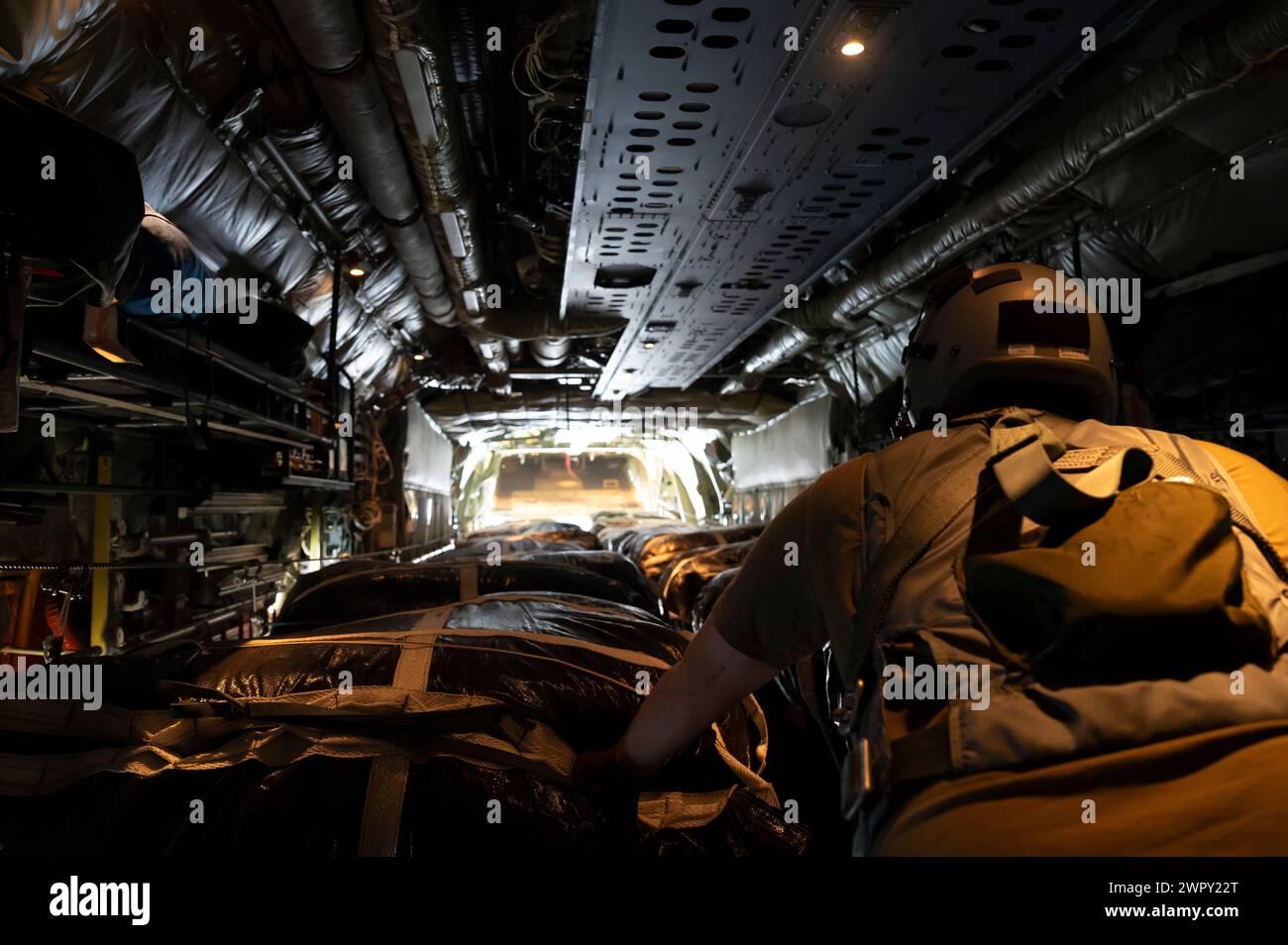 A U.S. Air Force loadmaster releases humanitarian aid pallets of ...