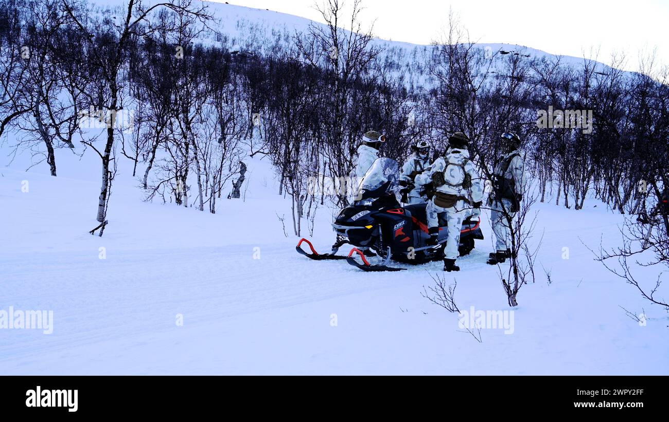 U.S. Air Force pararescuemen and a Swedish Ranger meet over a ...
