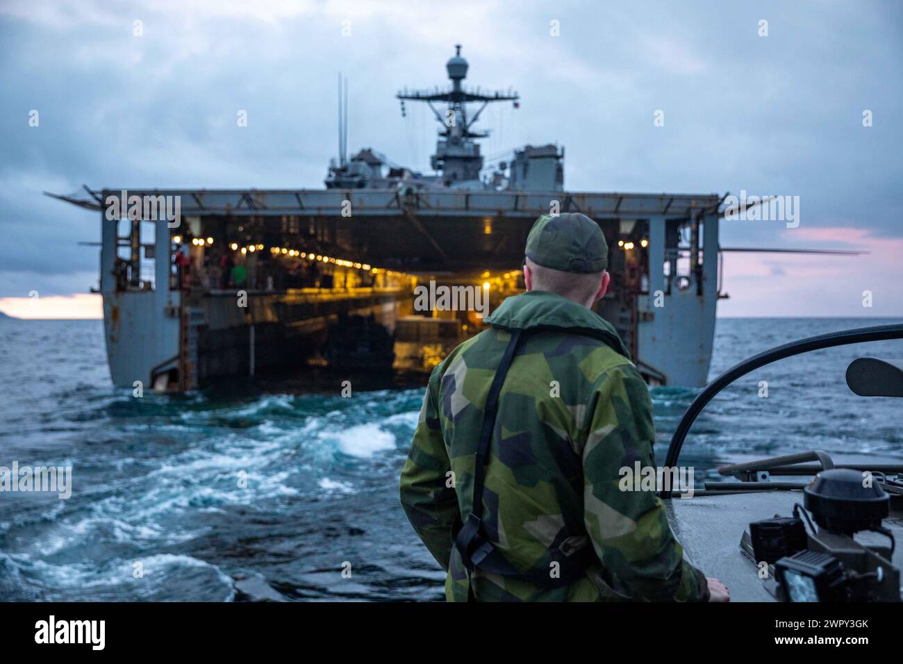 A Swedish Marine, assigned to 2nd Battalion, aboard a CB90-class fast assault craft, observes as ...