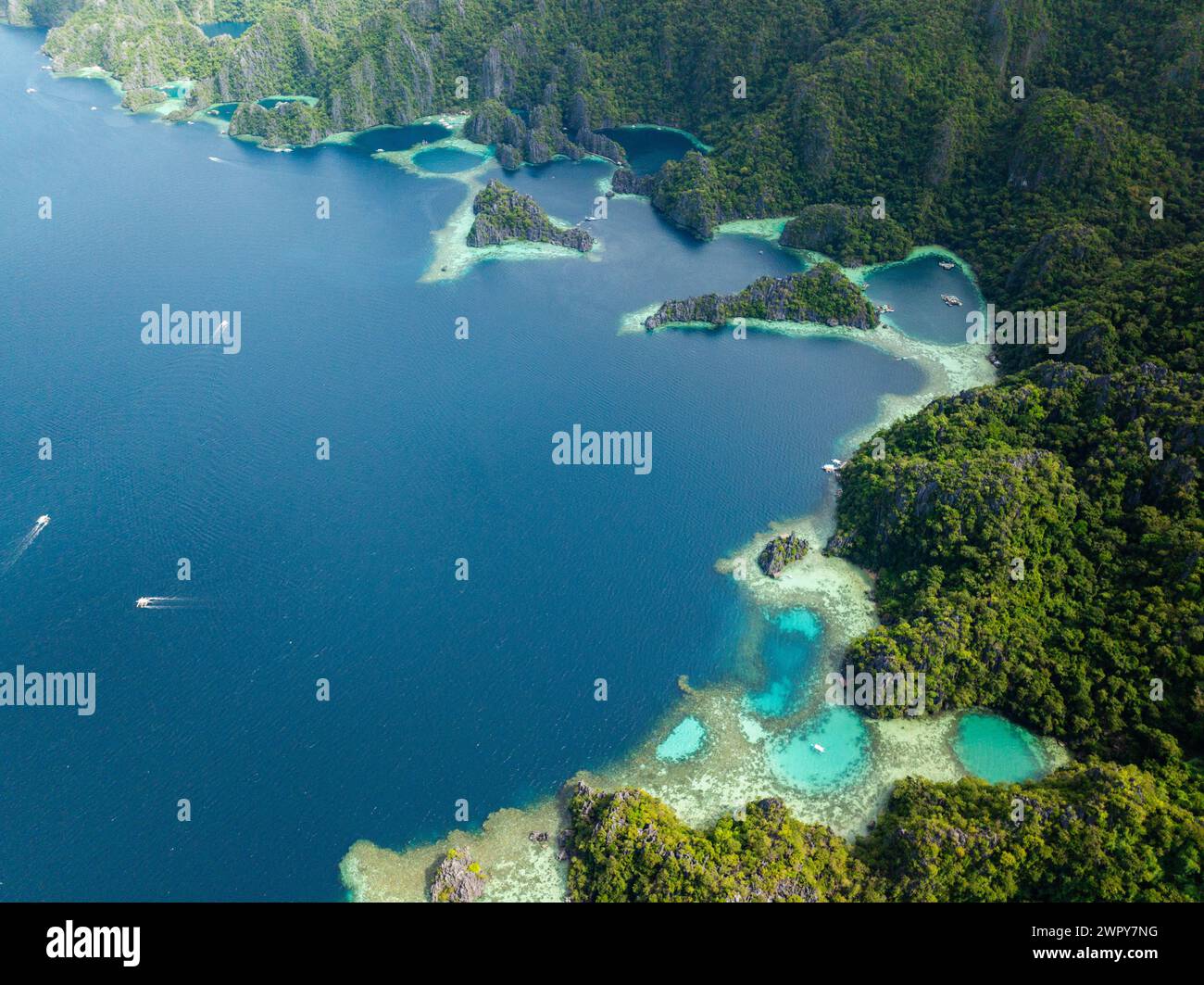 Lagoons with turquoise clear water and corals. Tour boats on blue sea ...