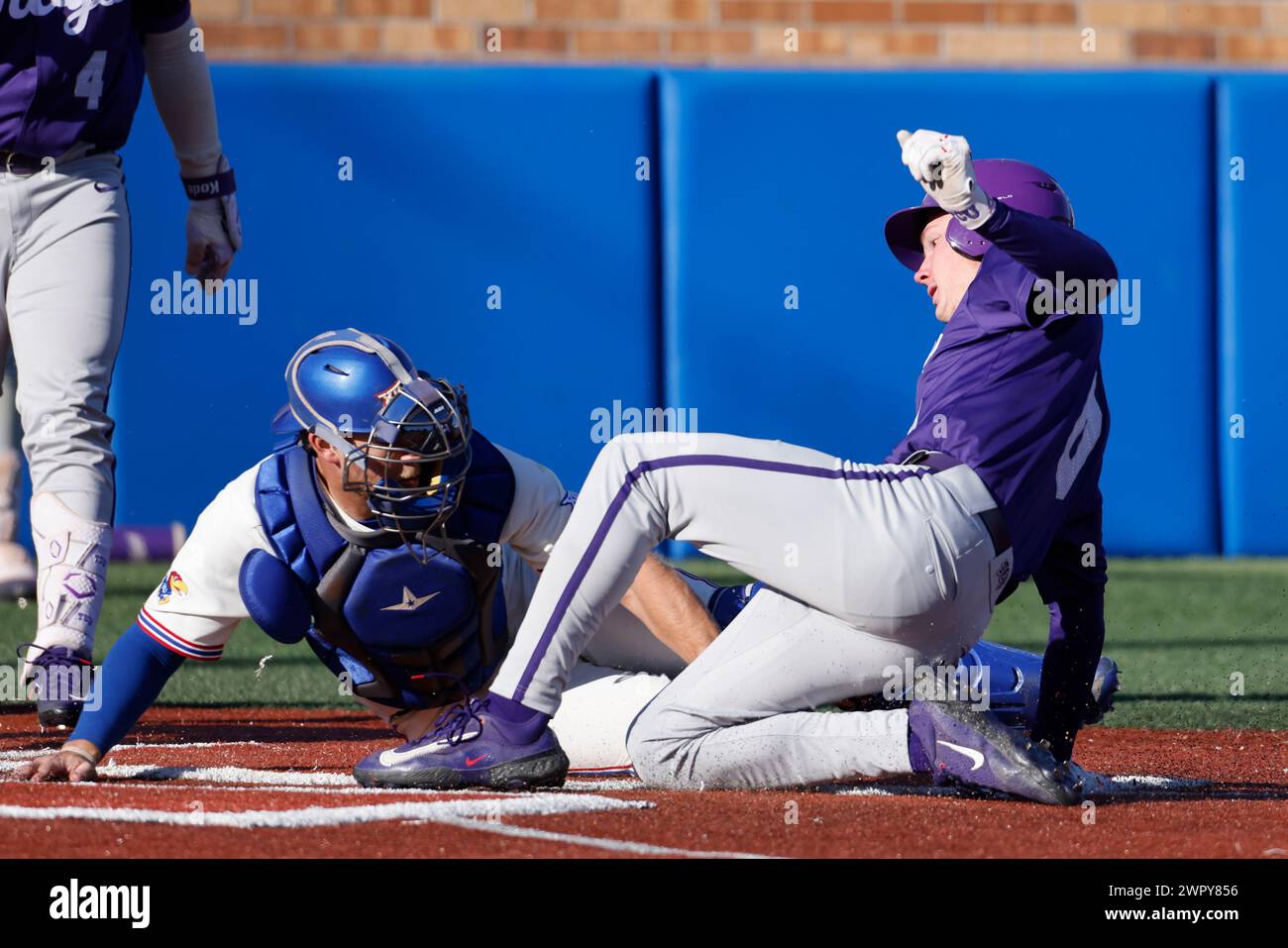 TCU's Ryder Robinson, right, is tagged out by Kansas catcher Jake ...