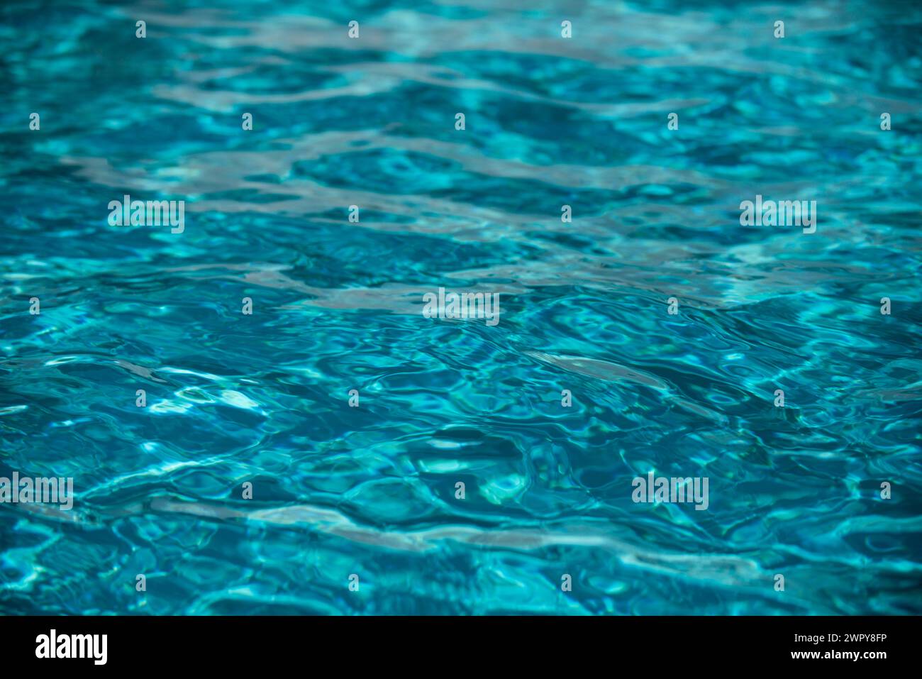 Background of blue water in swimming pool with sun reflection, ripple ...