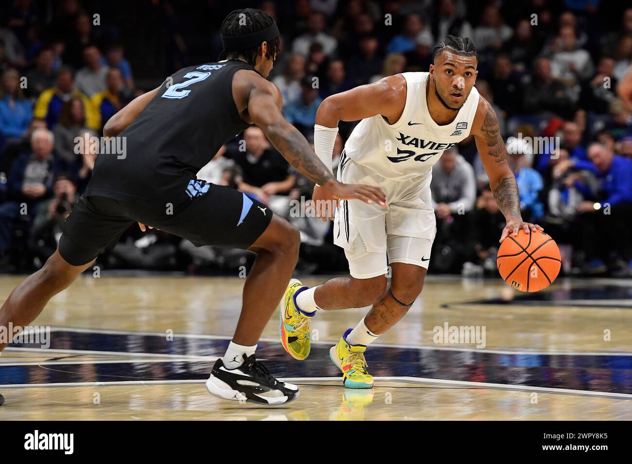 Xavier guard Dayvion McKnight (20) attempts to drive past Marquette ...