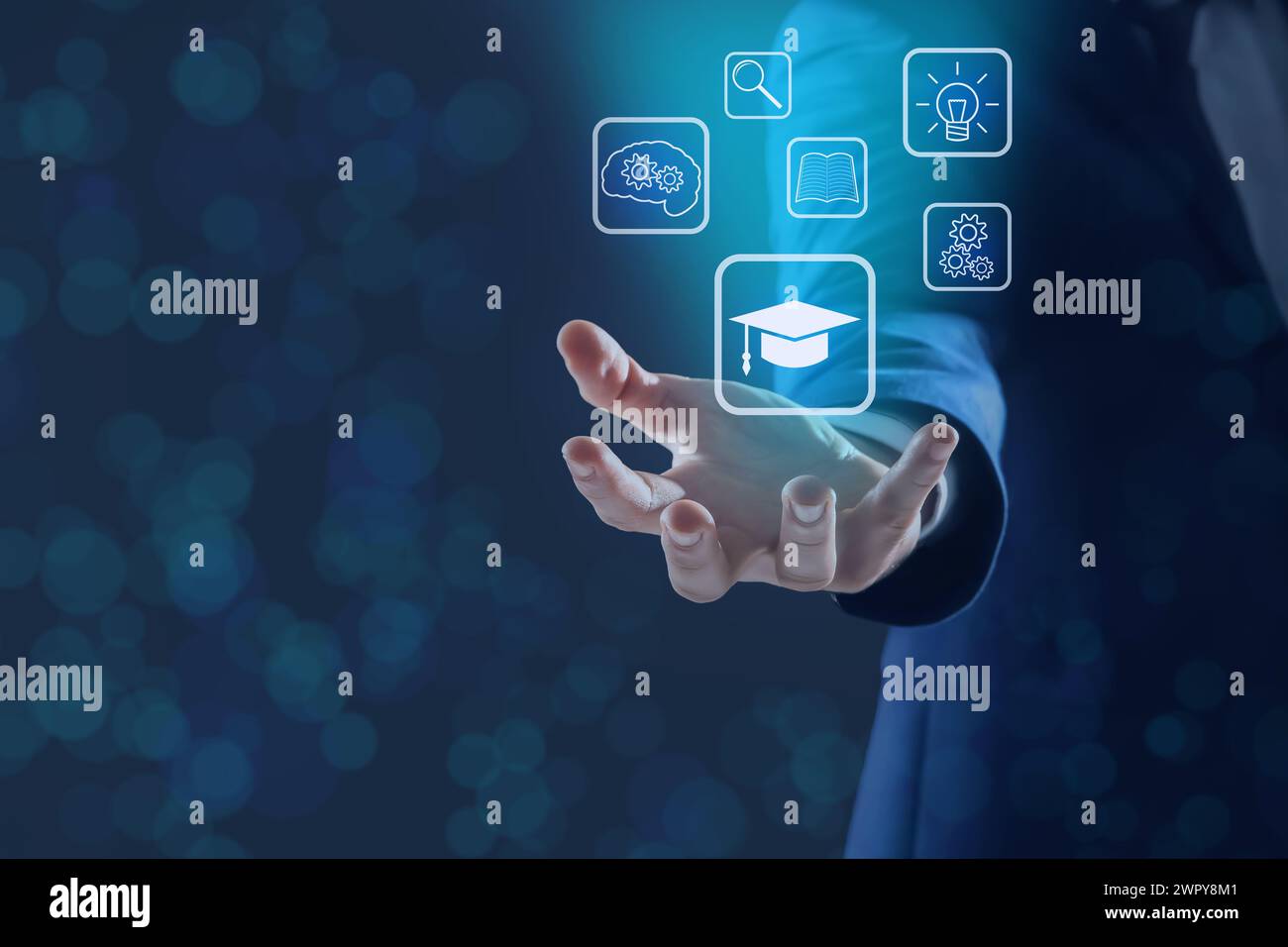 E-learning. Man showing different icons on virtual screen against dark ...