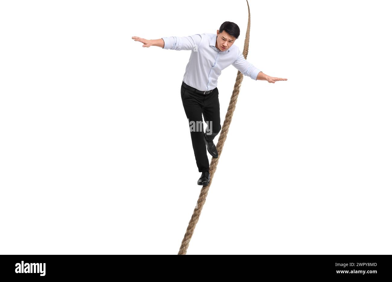 Risks and challenges of owning business. Man balancing on rope against ...
