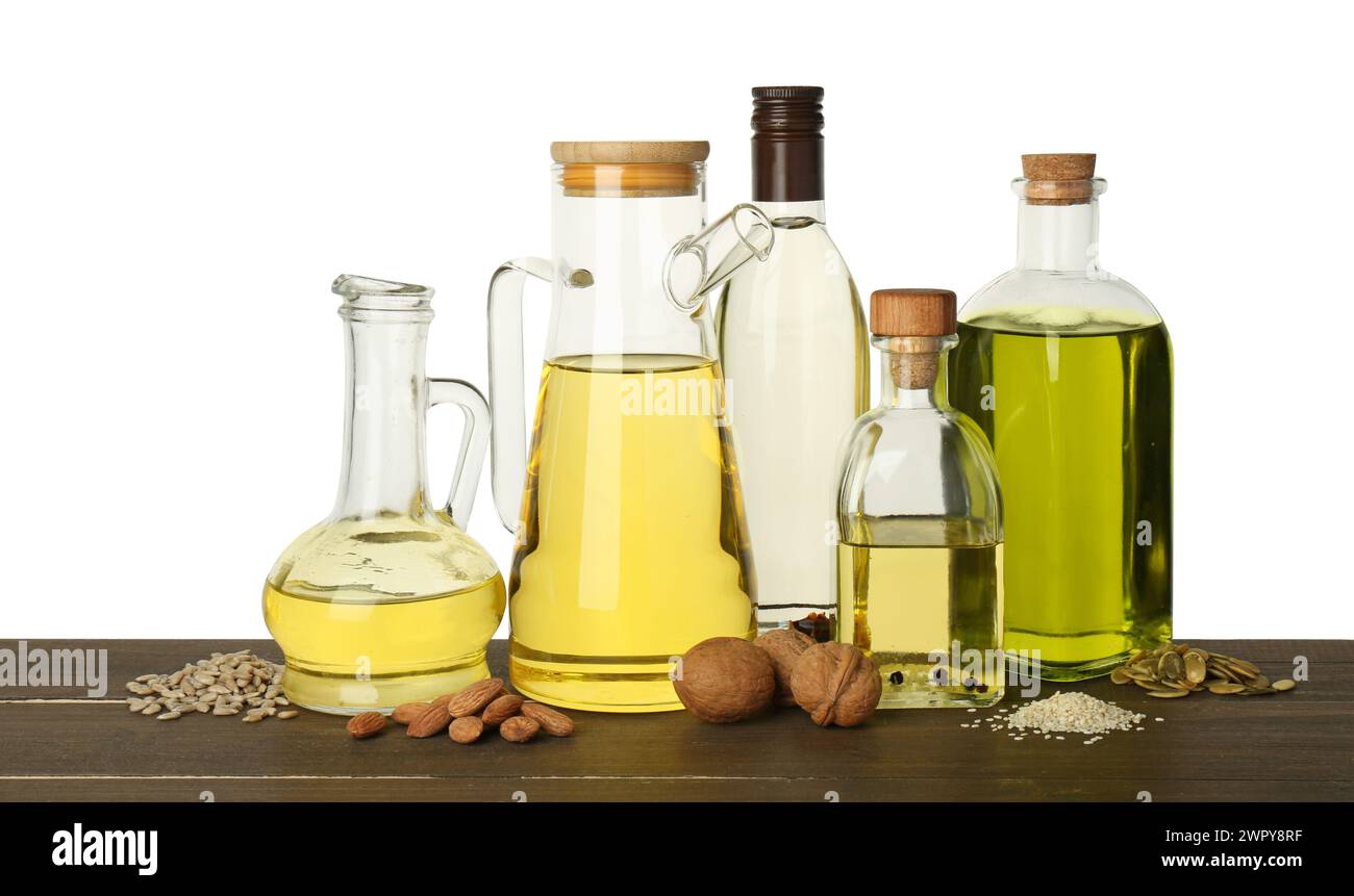Vegetable fats. Different cooking oils and ingredients on wooden table ...