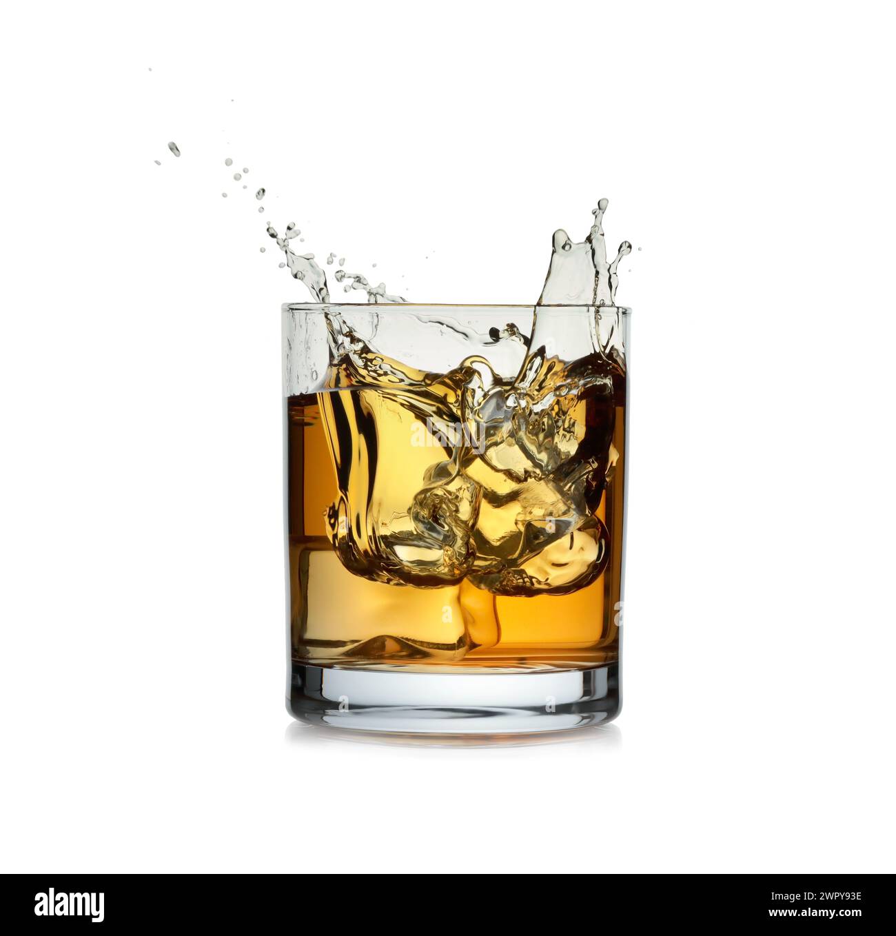 Whiskey splashing in glass isolated on white Stock Photo - Alamy