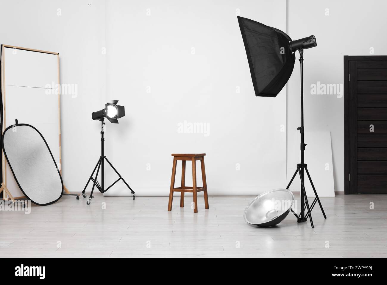 White photo background, stool and professional lighting equipment in ...