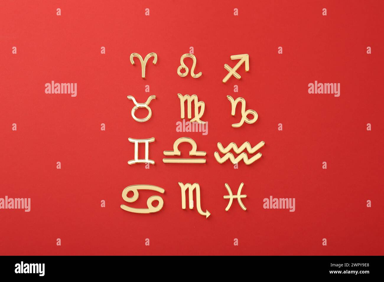 Zodiac signs on red background, flat lay Stock Photo - Alamy