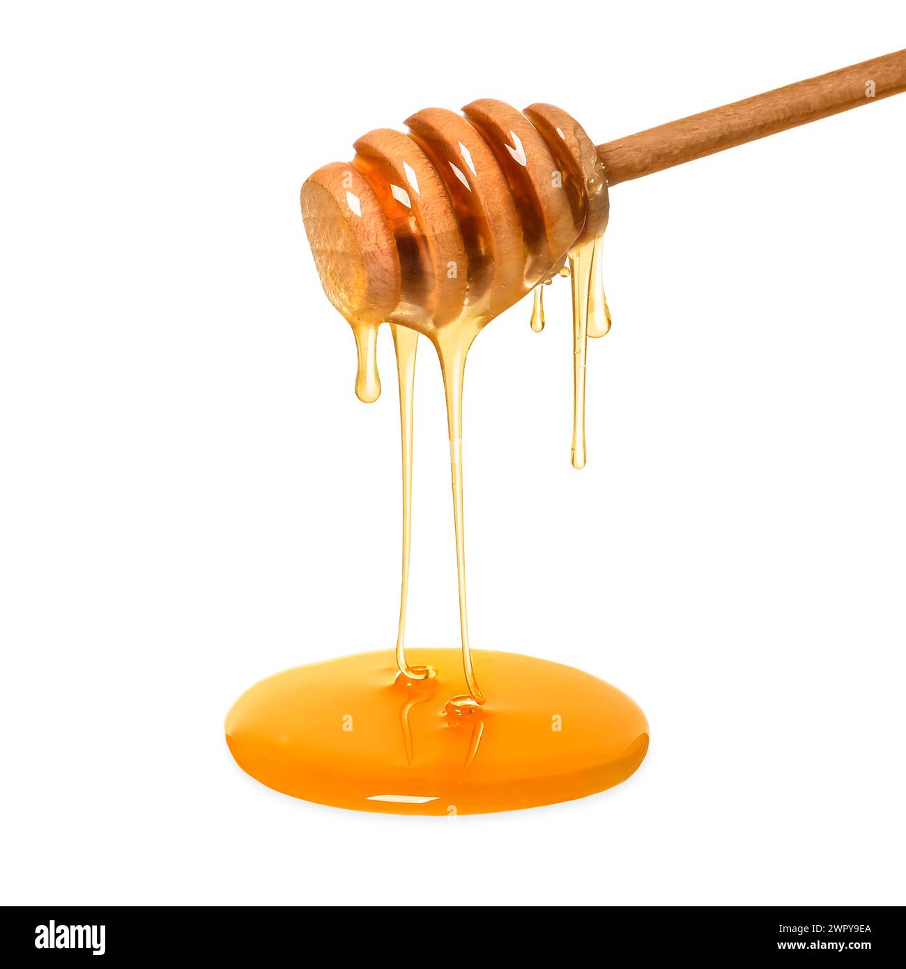 Natural honey dripping from dipper on white background Stock Photo - Alamy