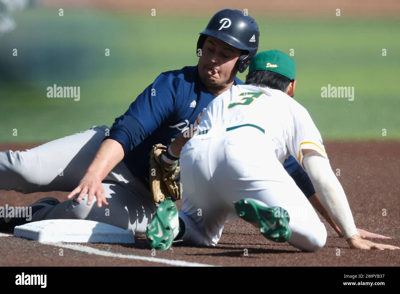 Saint Peter's base runner Dylan Brown (28) is tagged out by University ...