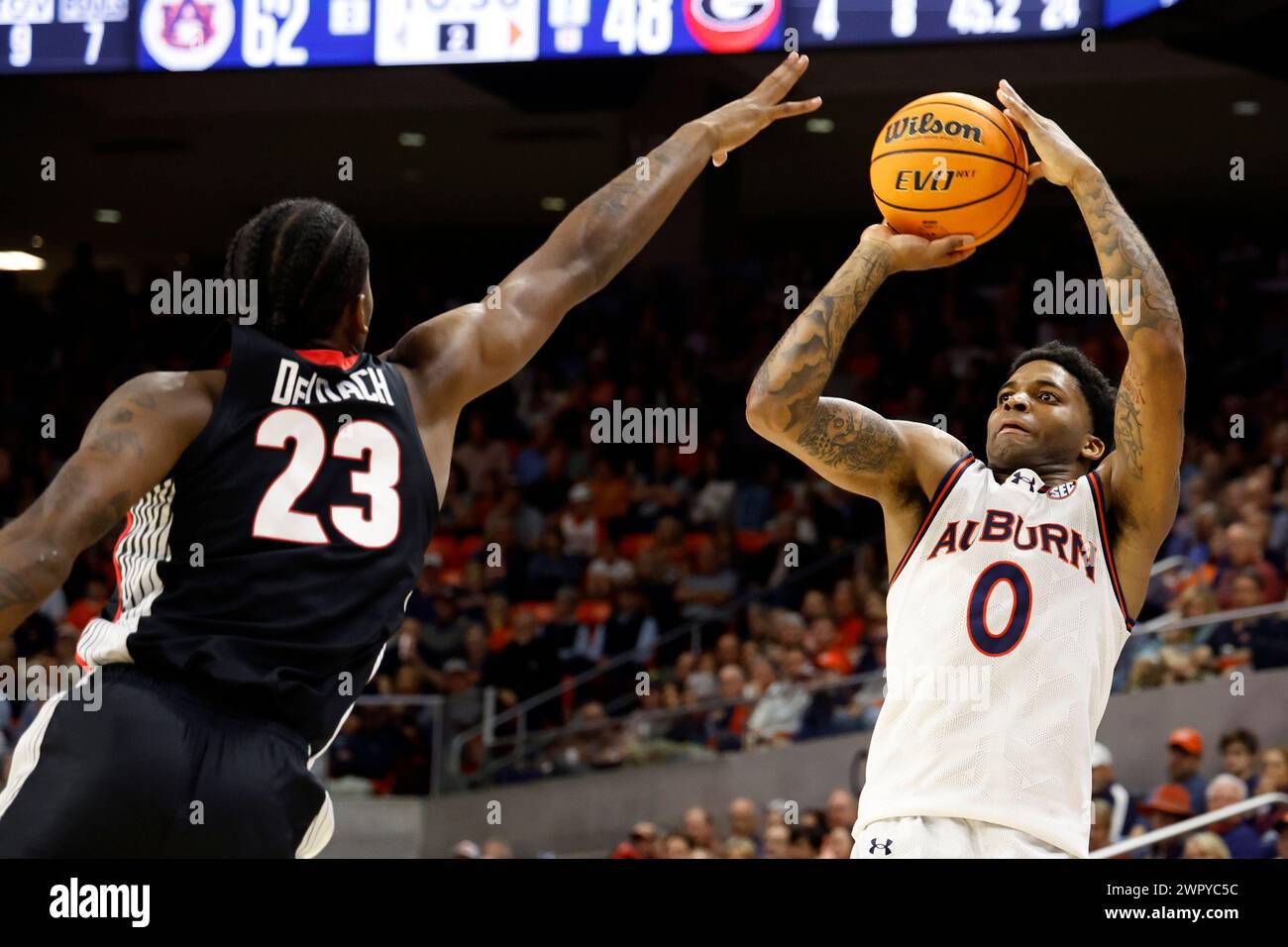 Auburn guard K.D. Johnson (0) shoots a 3-pointer over Georgia forward Jalen DeLoach (23) during ...