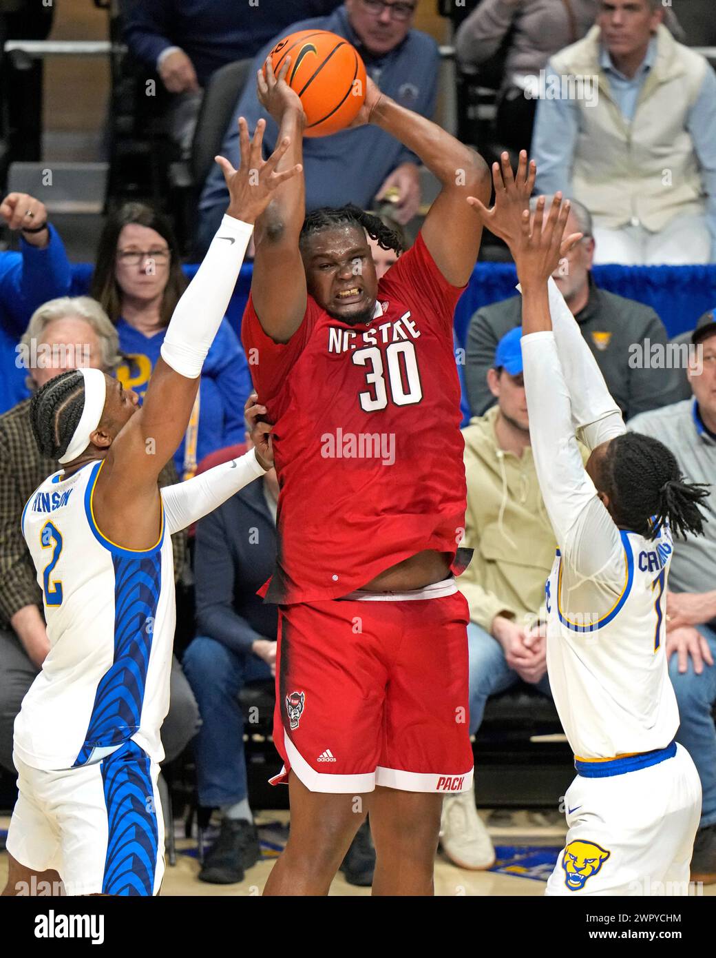North Carolina State's DJ Burns Jr. (30) works to get off a pass ...
