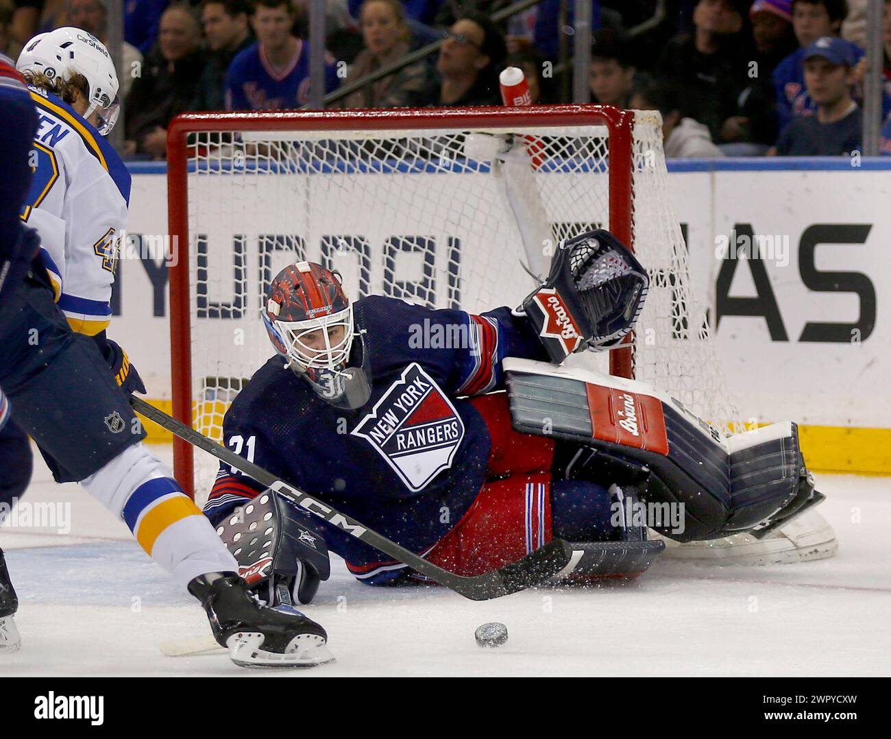 New York Rangers goalie Igor Shesterkin, right, makes a sliding save ...