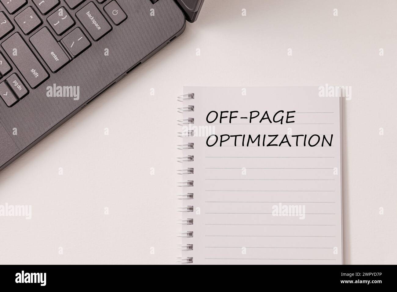 Black laptop and notebook have text Off-page Optimization on the white ...