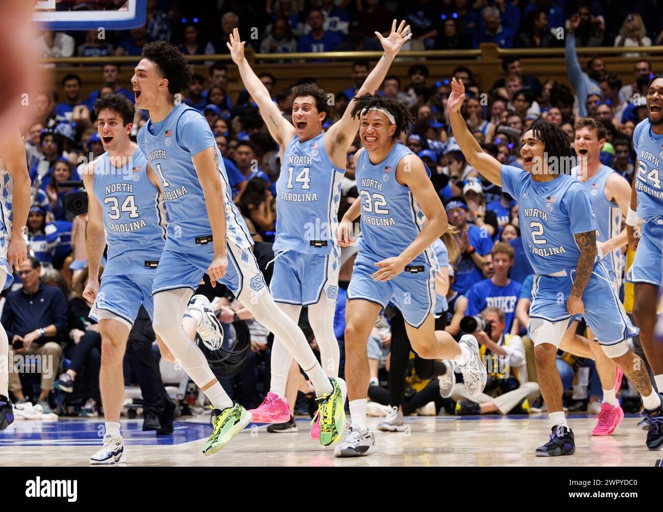 The North Carolina bench runs onto the court to celebrate after beating ...