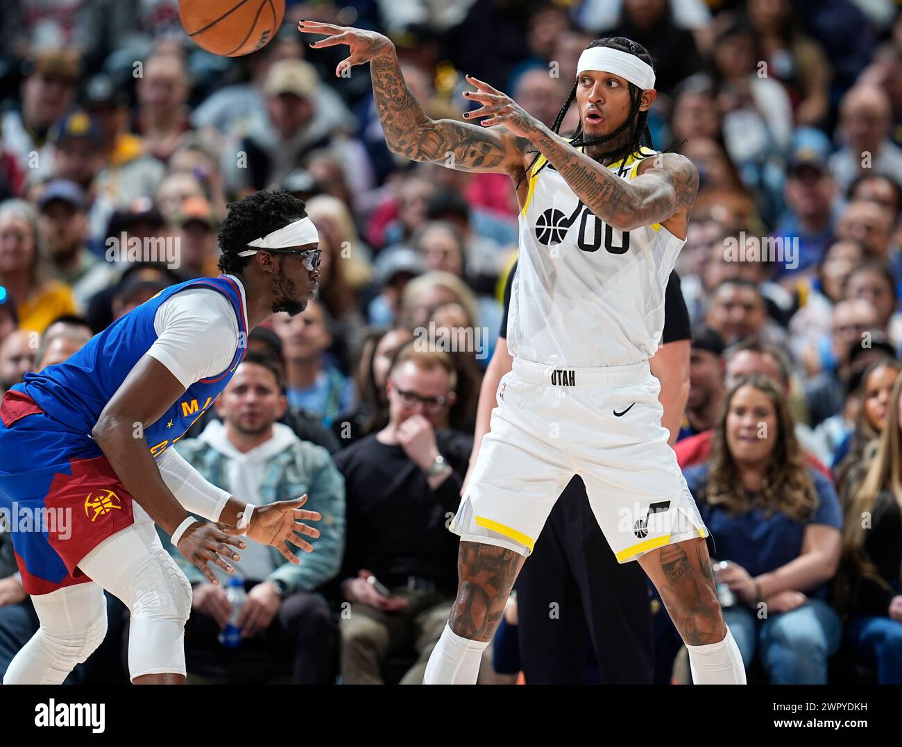Utah Jazz guard Jordan Clarkson, right, passes the ball as Denver ...